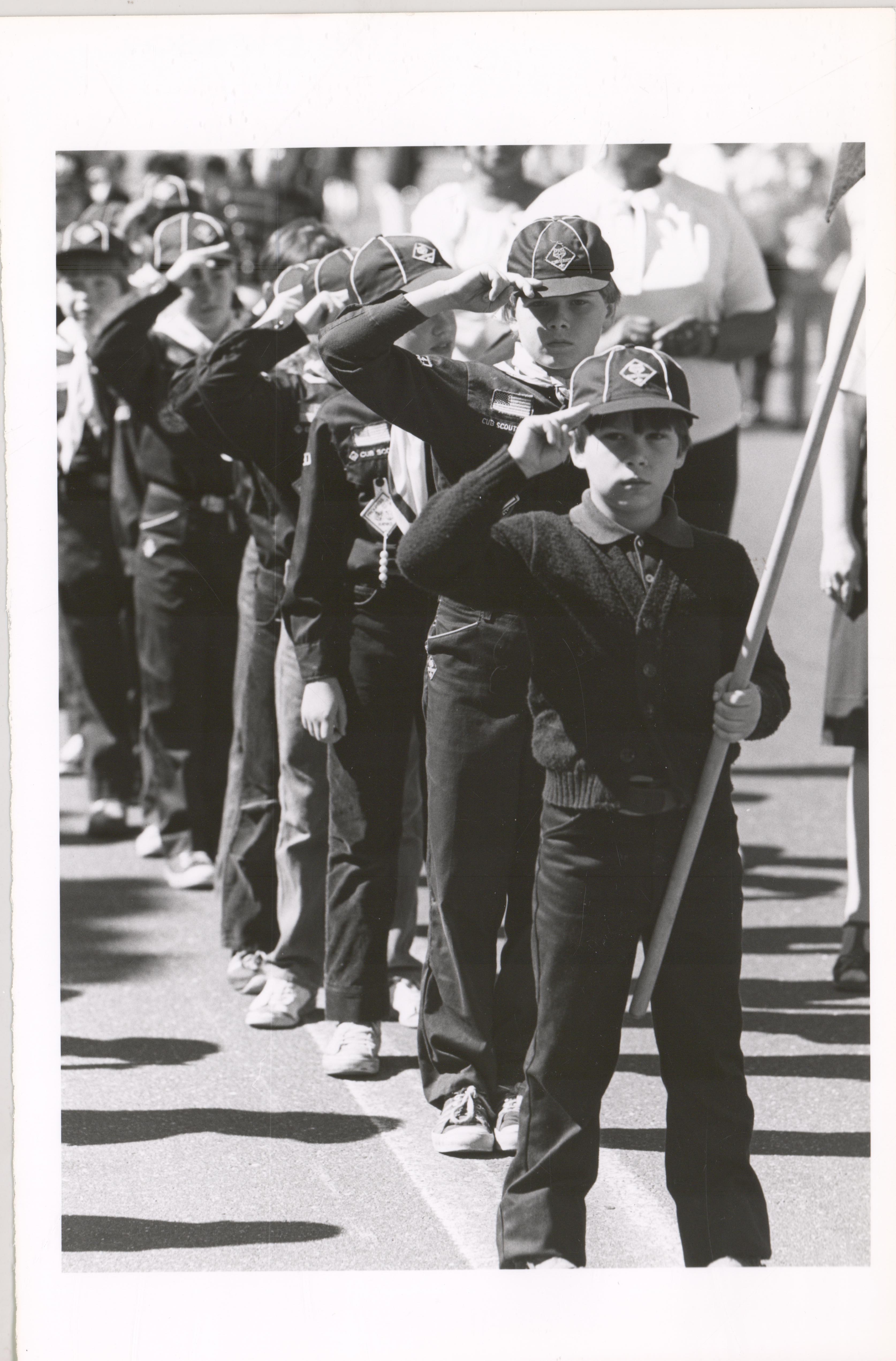 A line of Cub Scouts Saluting
